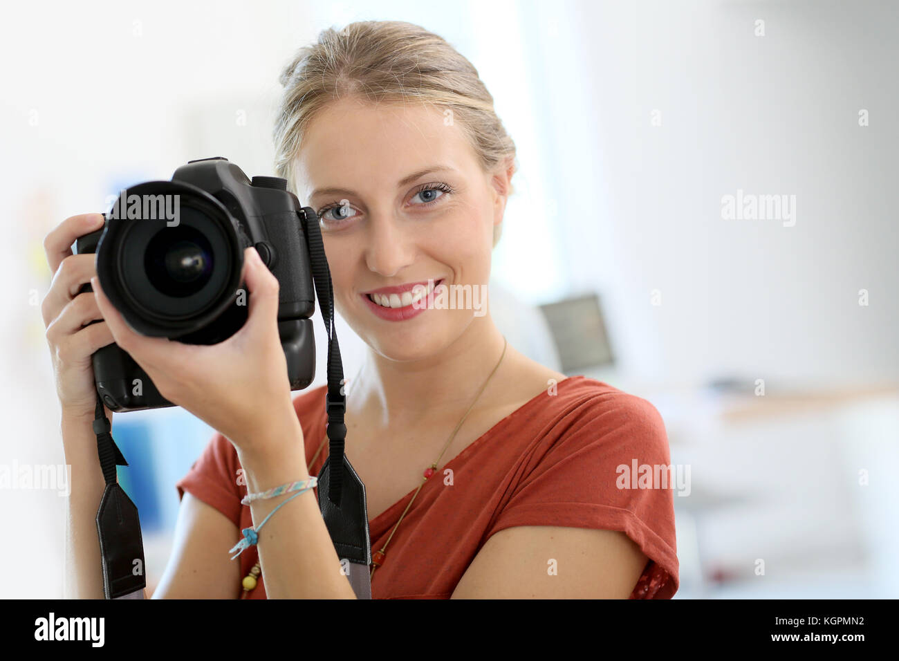 Cheerful young woman in photography training class Stock Photo - Alamy