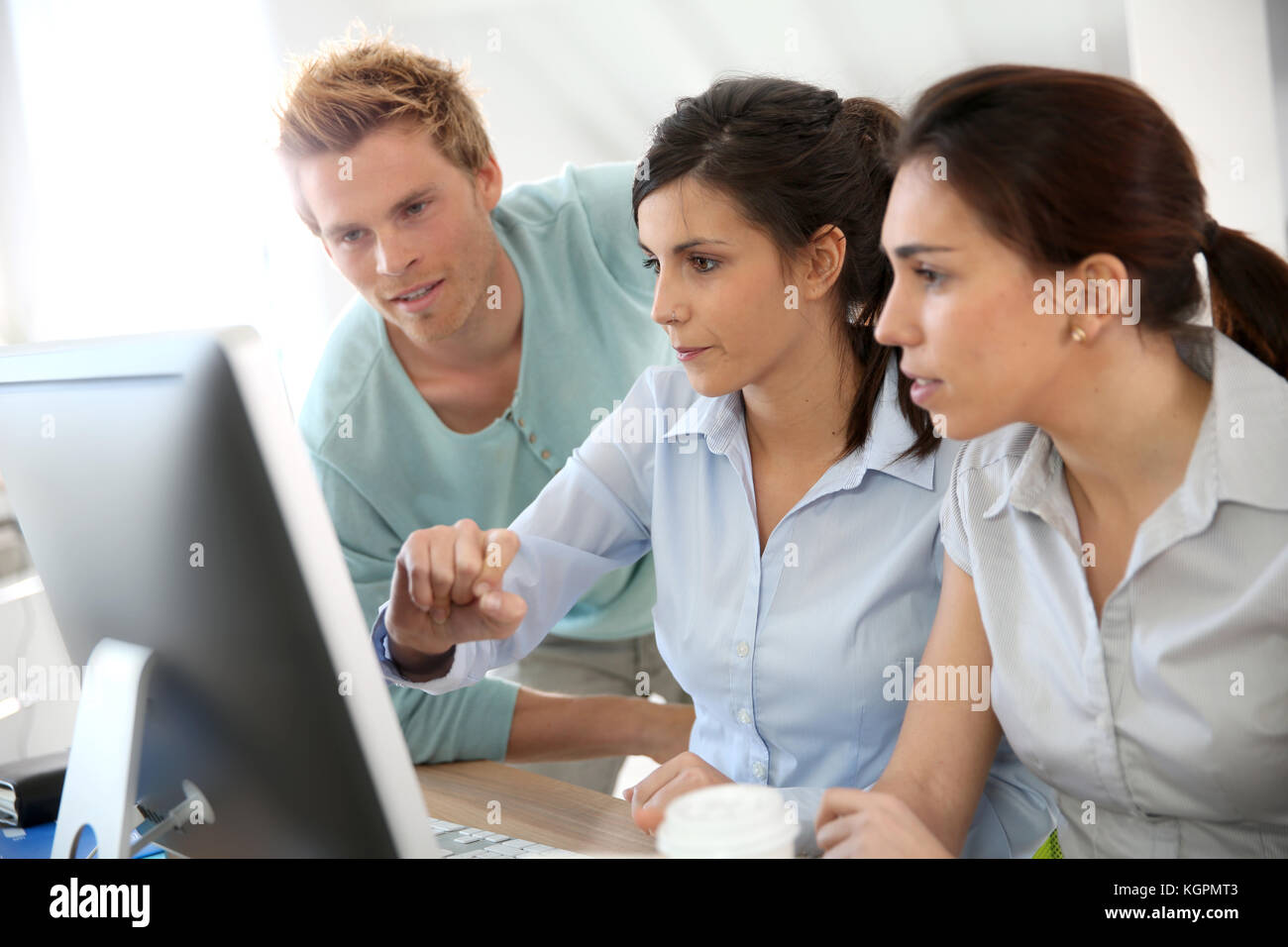 Group of young adults in business training Stock Photo - Alamy