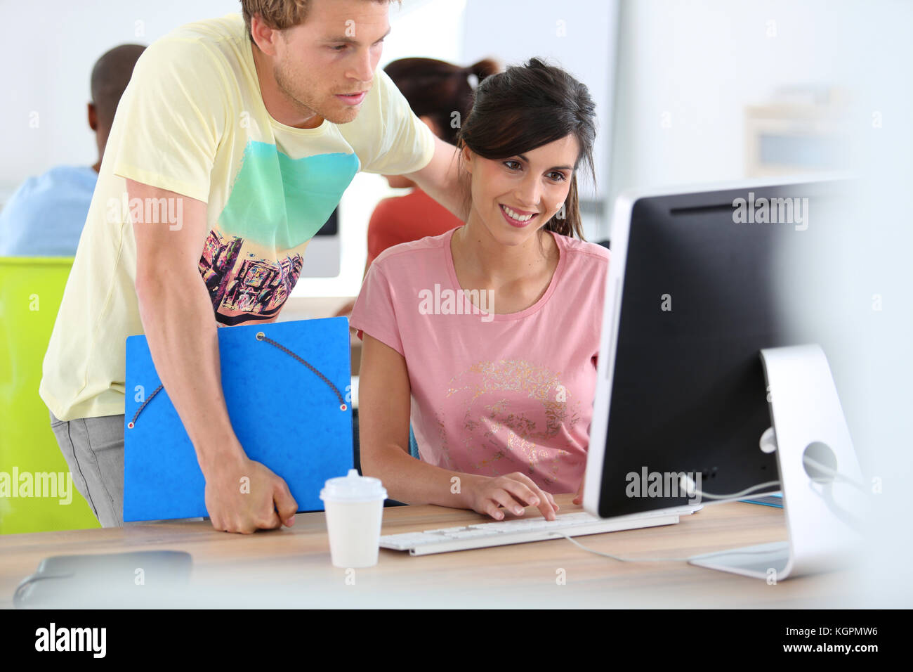 Young people in business class working on desktop Stock Photo - Alamy