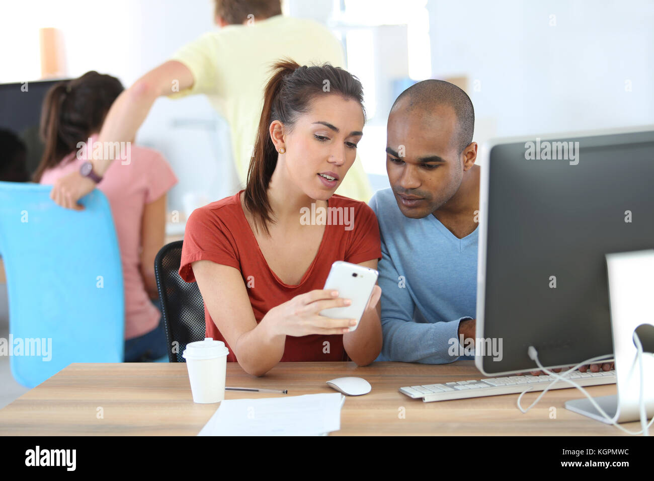 Students in class reading message on smartphone Stock Photo - Alamy