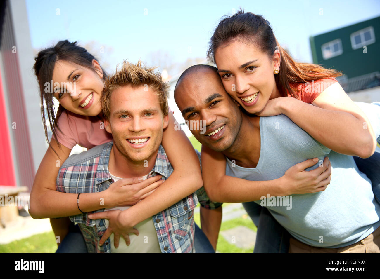 Group of students having fun outside college campus Stock Photo - Alamy