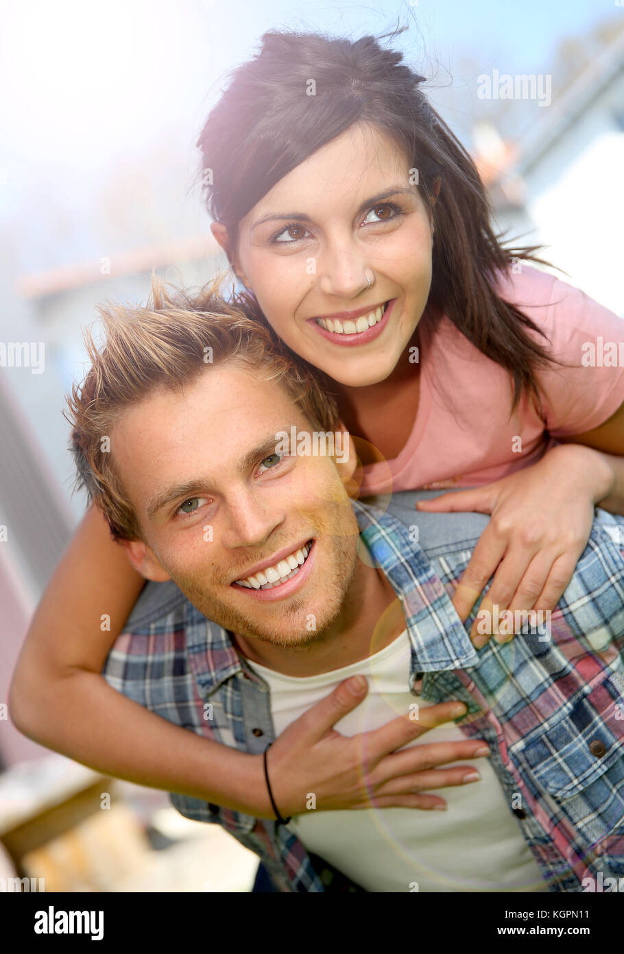 Young man giving piggyback ride to girlfriend Stock Photo - Alamy