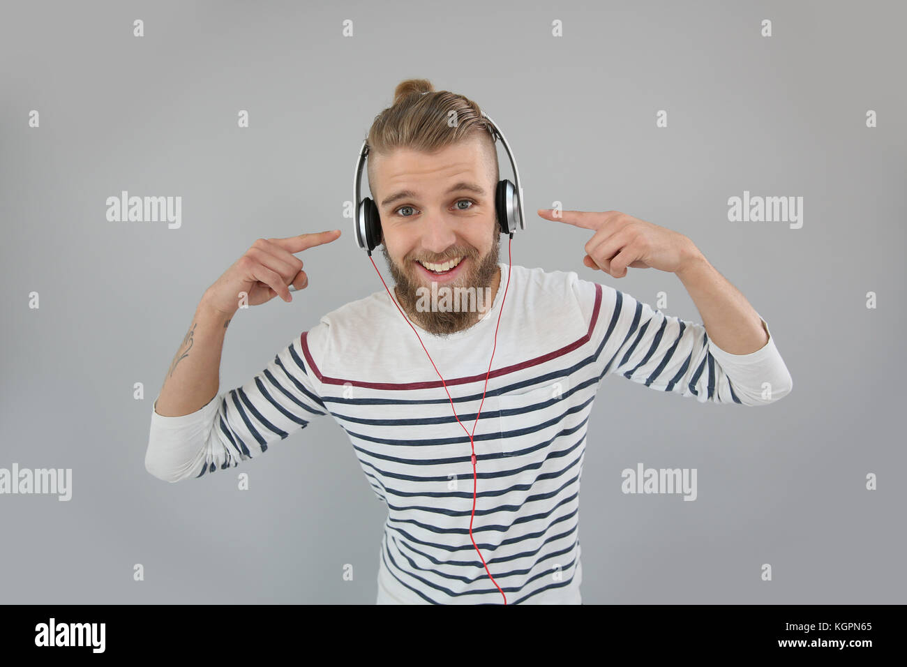 Cheerful trendy guy listening to music Stock Photo - Alamy