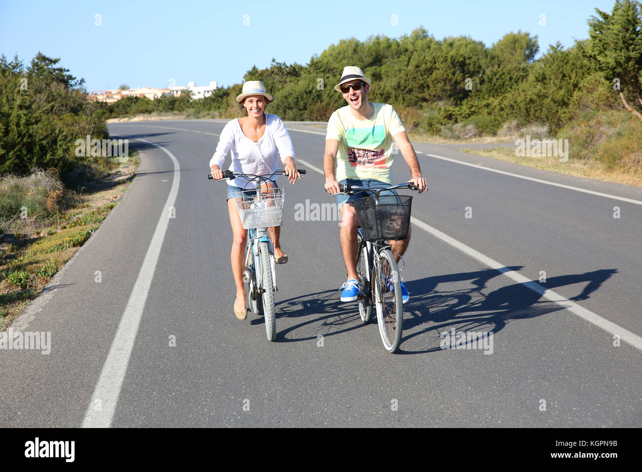 Couple having fun riding bicycles Stock Photo - Alamy