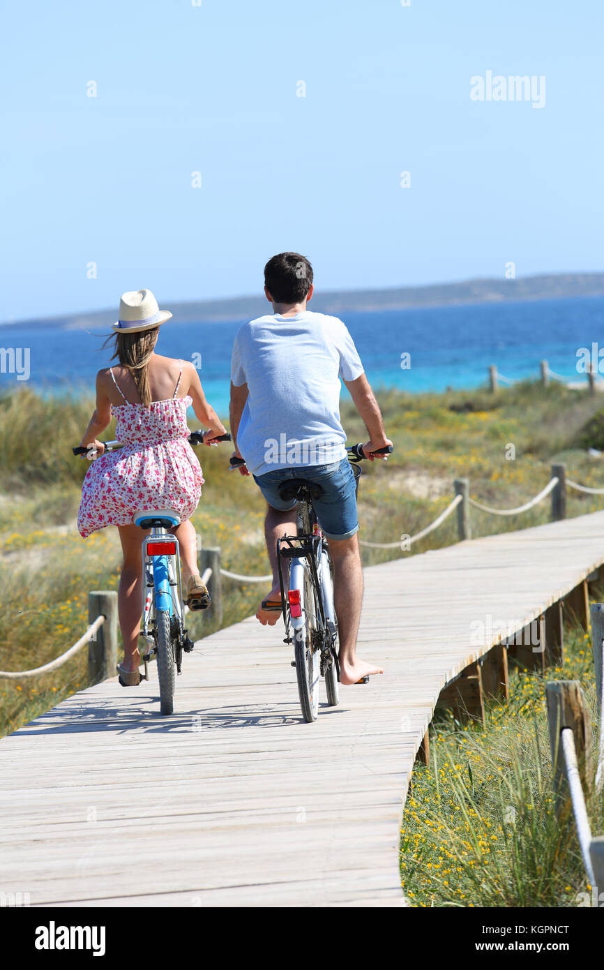 Couple riding bikes on Formentera Island Stock Photo - Alamy