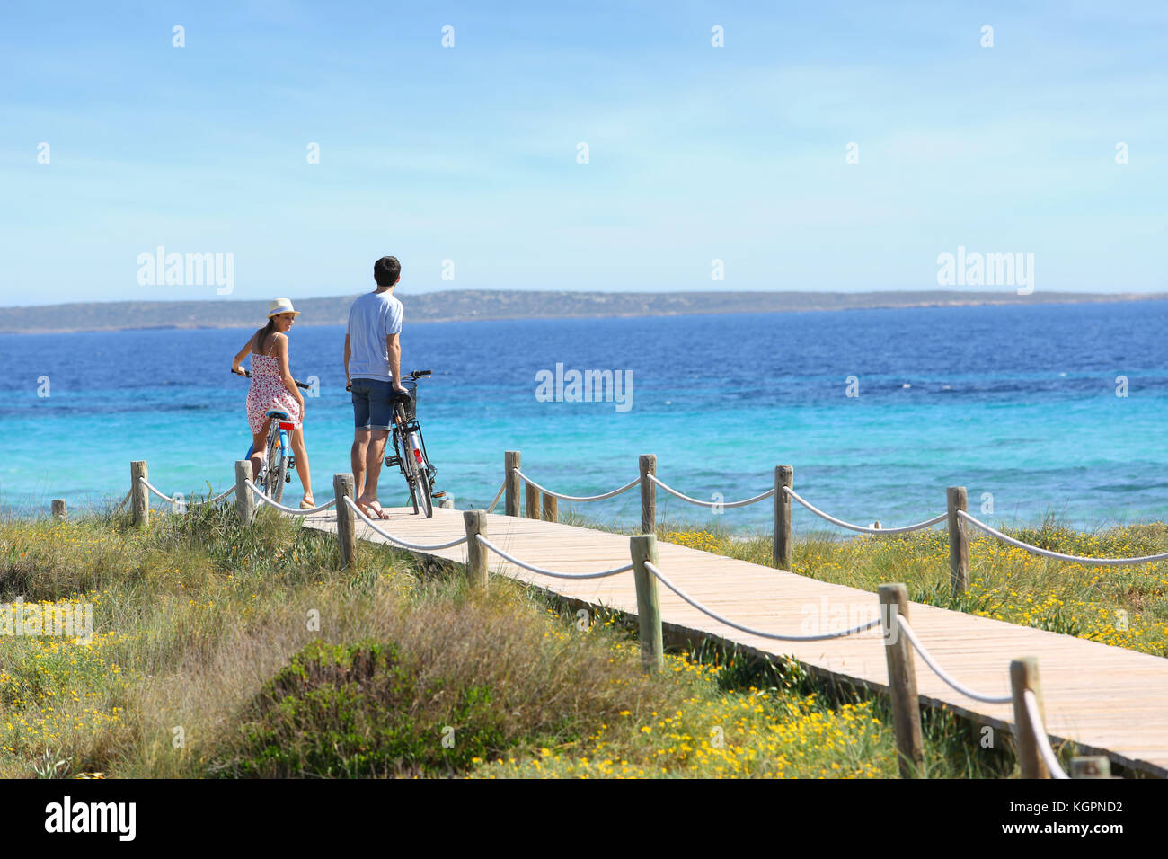 Couple riding bikes on Formentera Island Stock Photo - Alamy