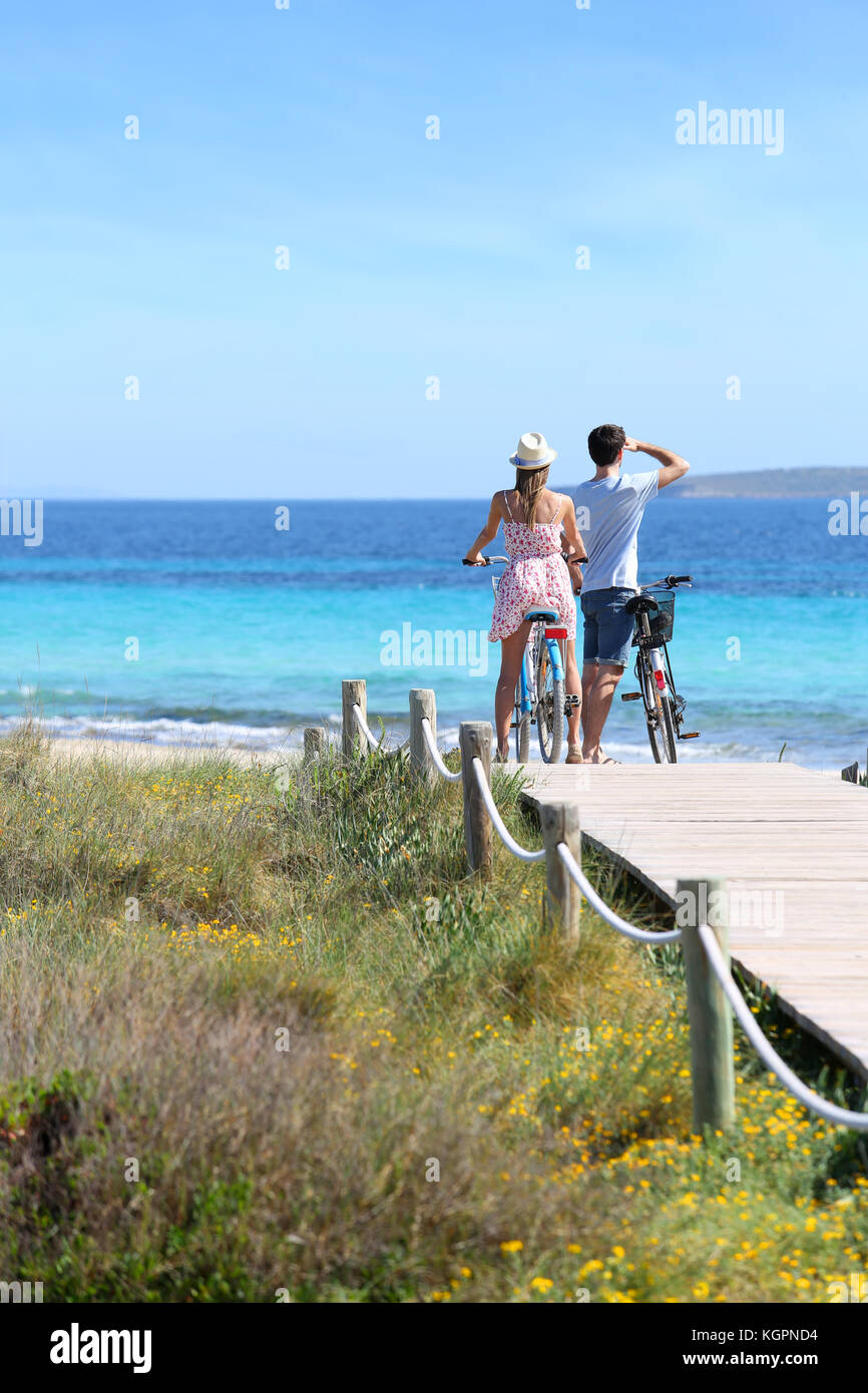 Couple riding bikes on Formentera Island Stock Photo - Alamy