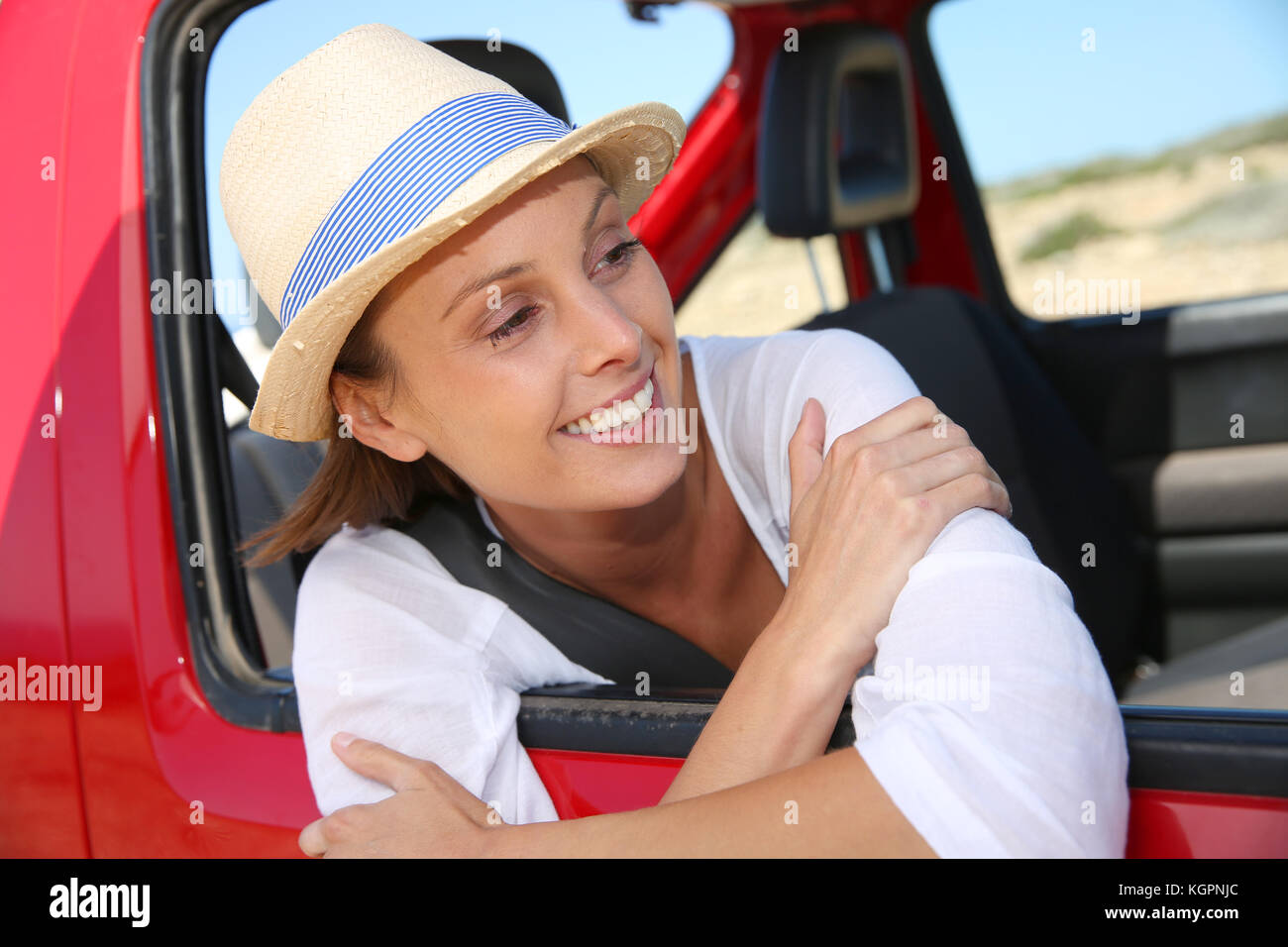 Portrait of smiling girl at red car window Stock Photo - Alamy