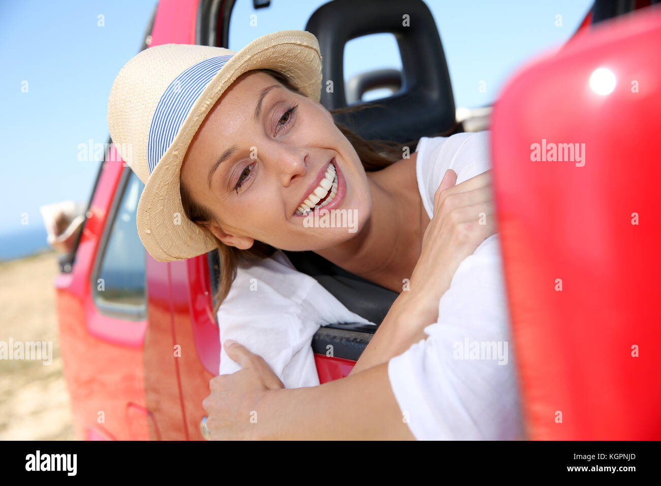 Portrait of smiling girl at red car window Stock Photo - Alamy