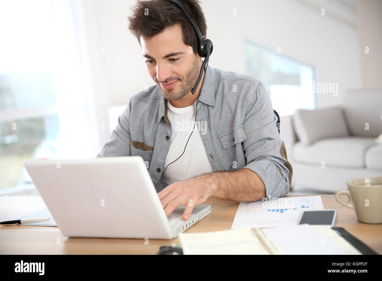 Man working from home with laptop Stock Photo - Alamy