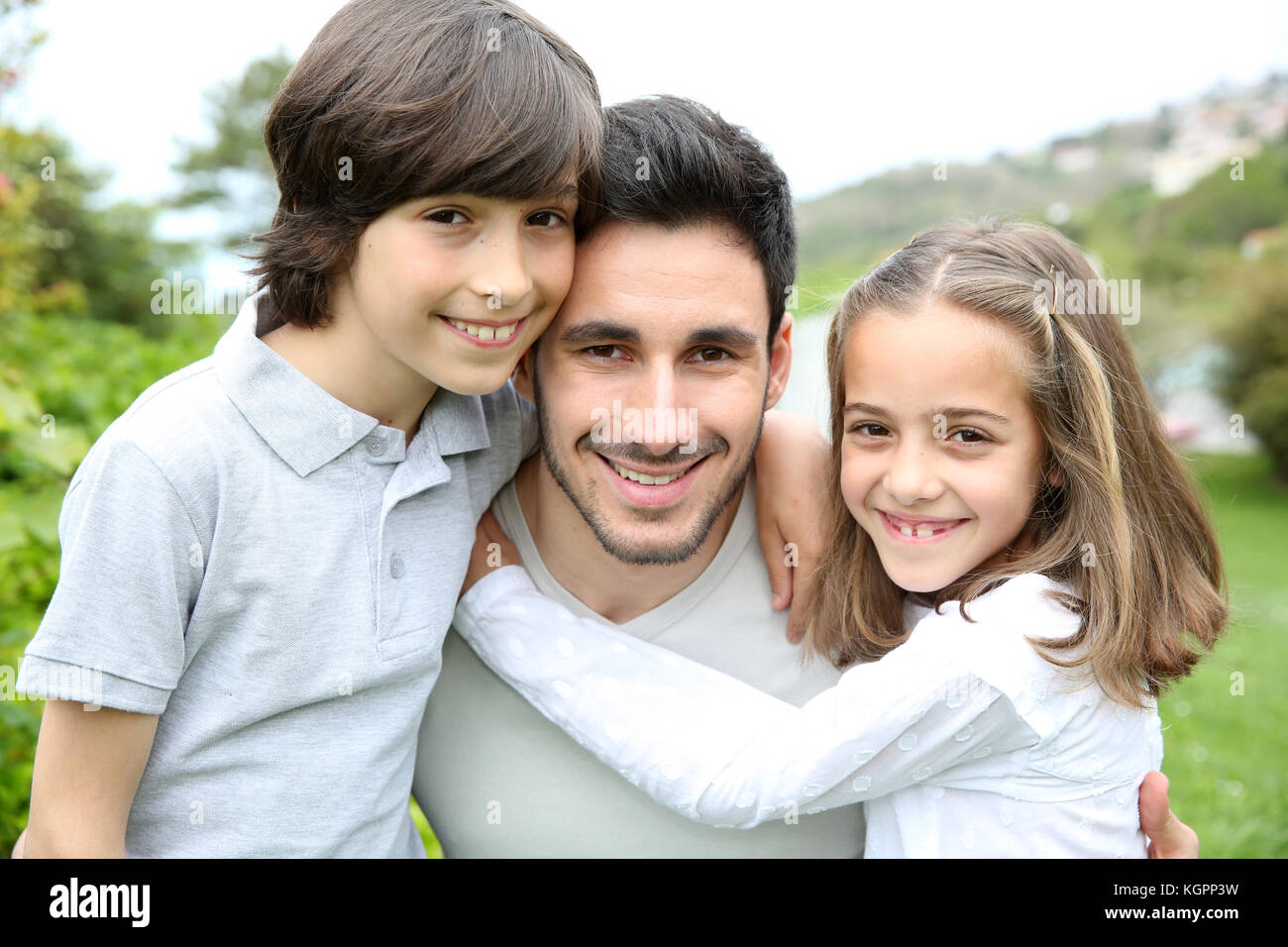 Portrait of young man with 2 kids Stock Photo - Alamy