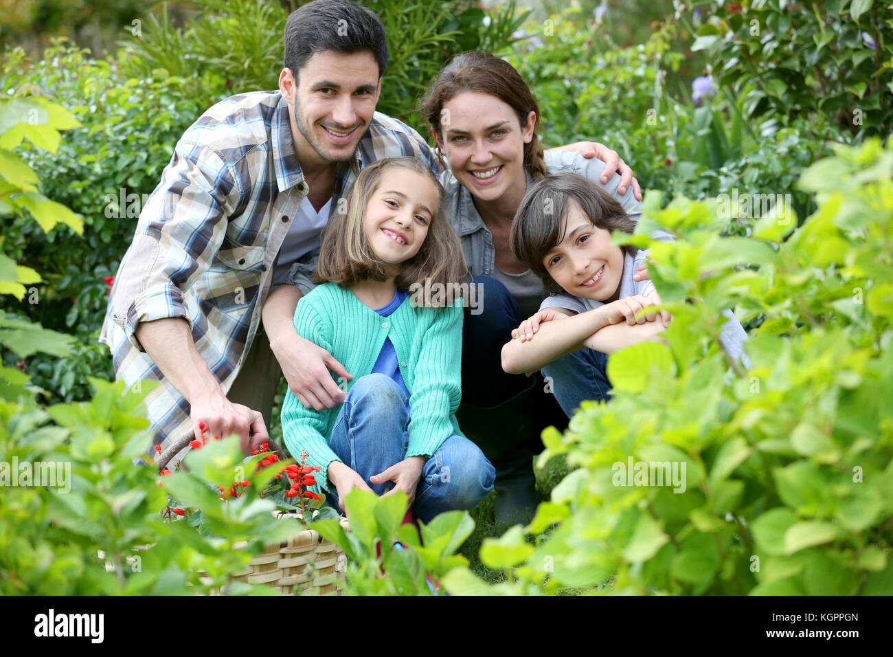 Portrait of happy family gardening together Stock Photo - Alamy
