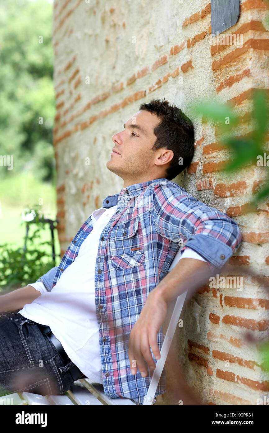 Man relaxing on bench during week-end in countryside Stock Photo - Alamy