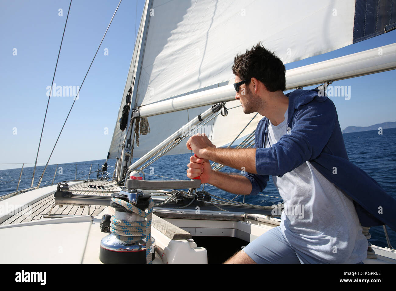 Man sailing with sails out on a sunny day Stock Photo - Alamy