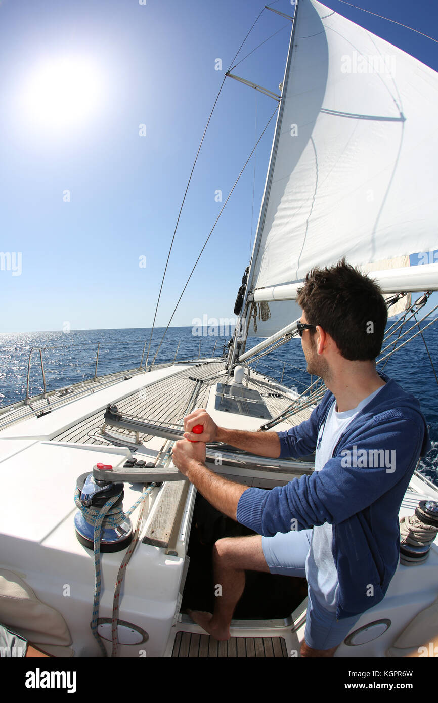 Man sailing with sails out on a sunny day Stock Photo - Alamy