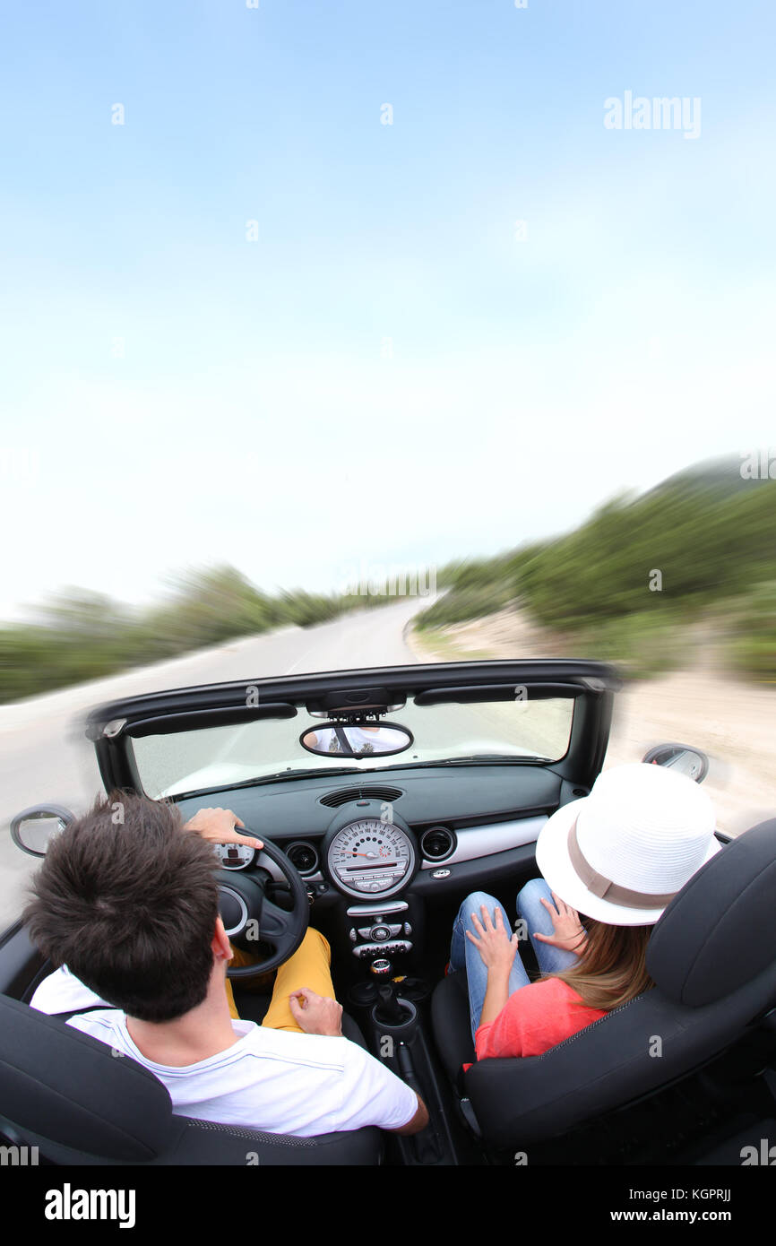 Young couple driving convertible car Stock Photo - Alamy