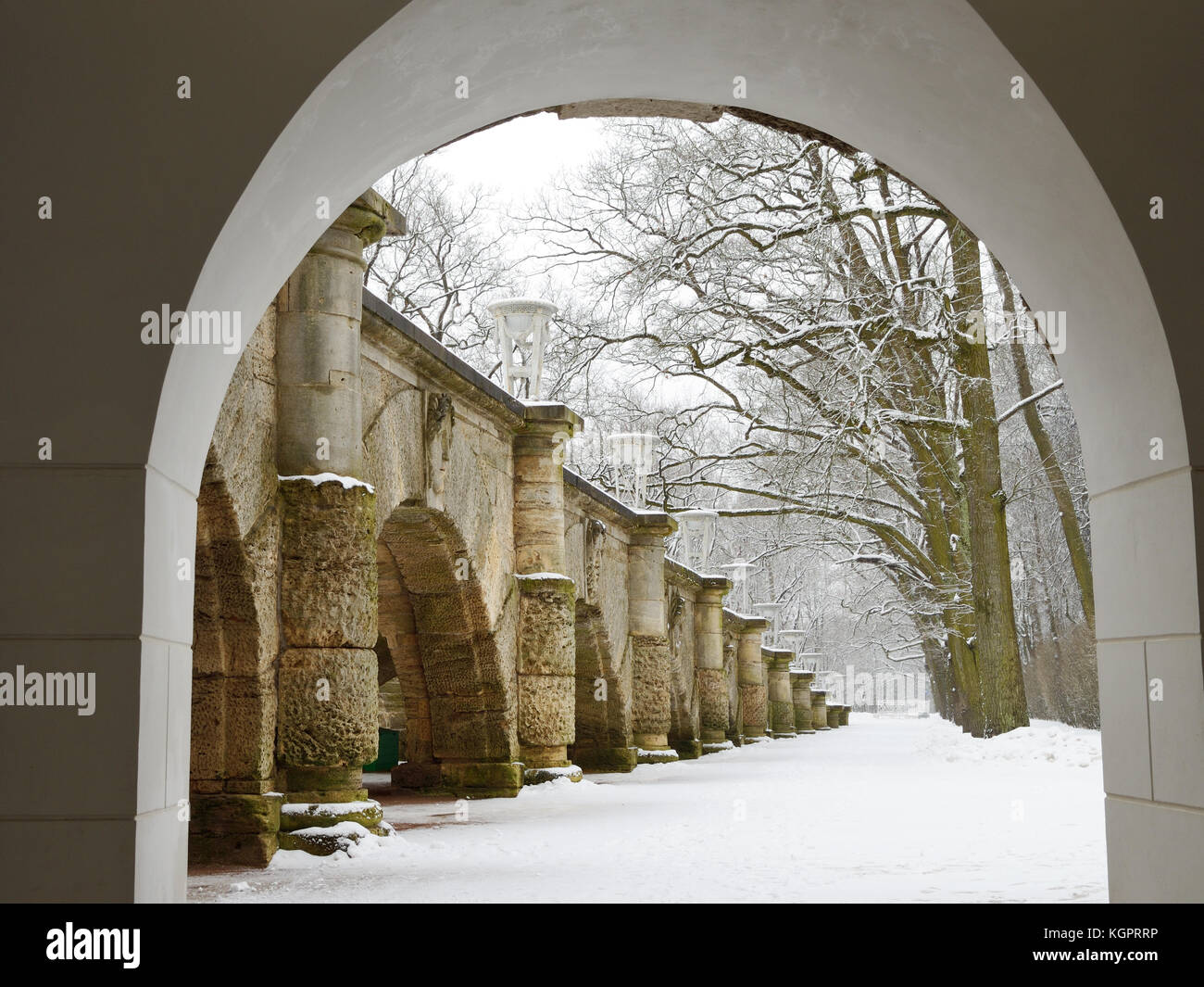 Through the arch of the building is seen a colorful bridge across the ...