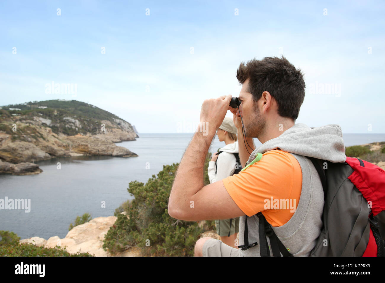 Man using binoculars on a hiking day Stock Photo - Alamy