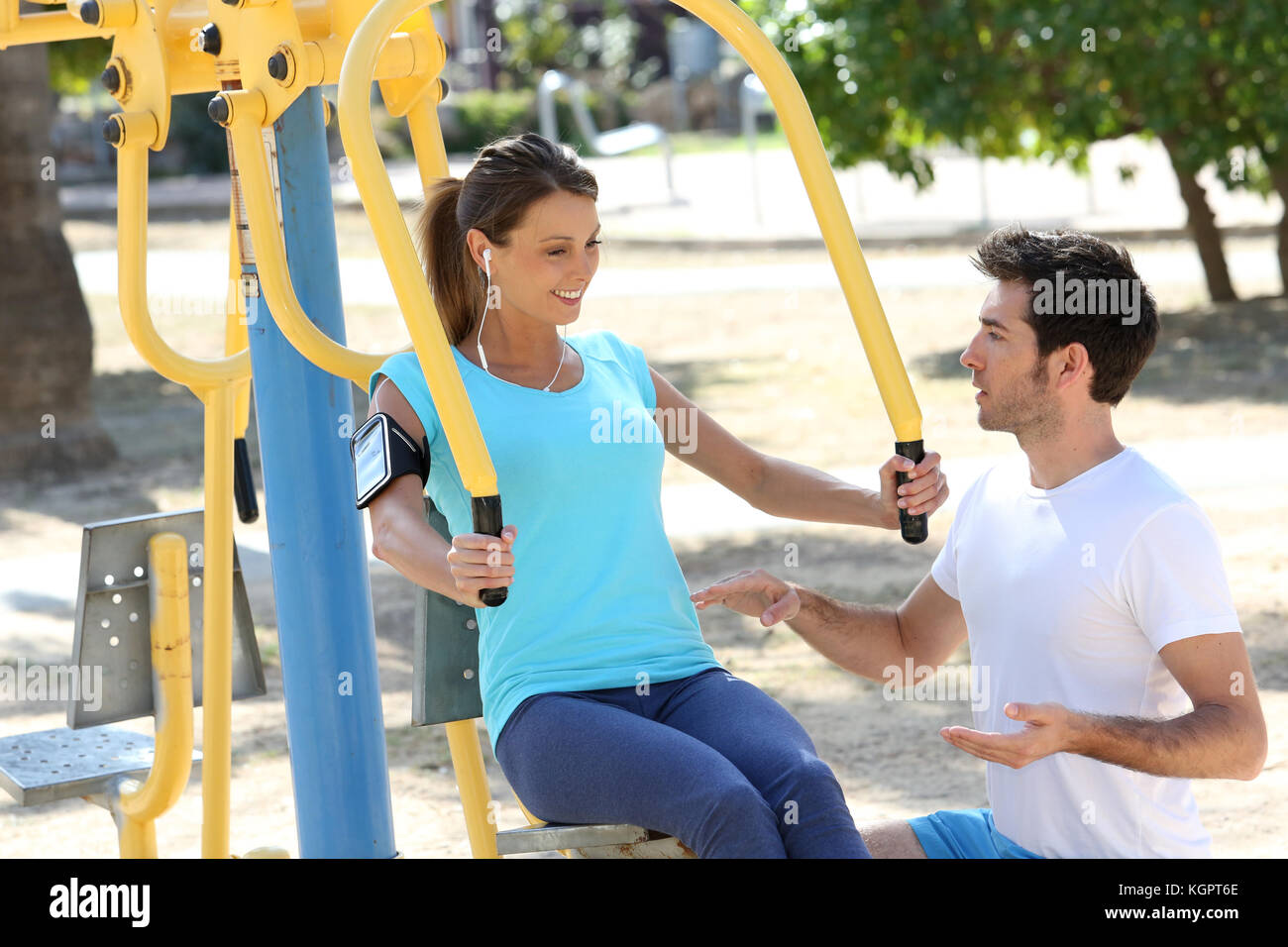 Fitness girl training with help of sports coach Stock Photo - Alamy
