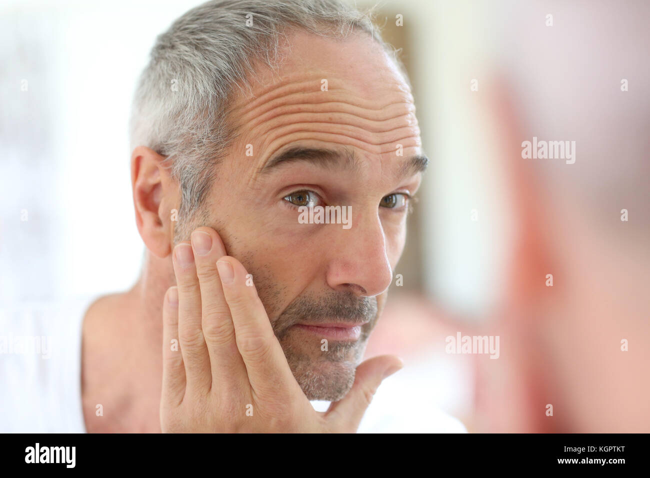 Senior man in front mirror hi-res stock photography and images - Alamy