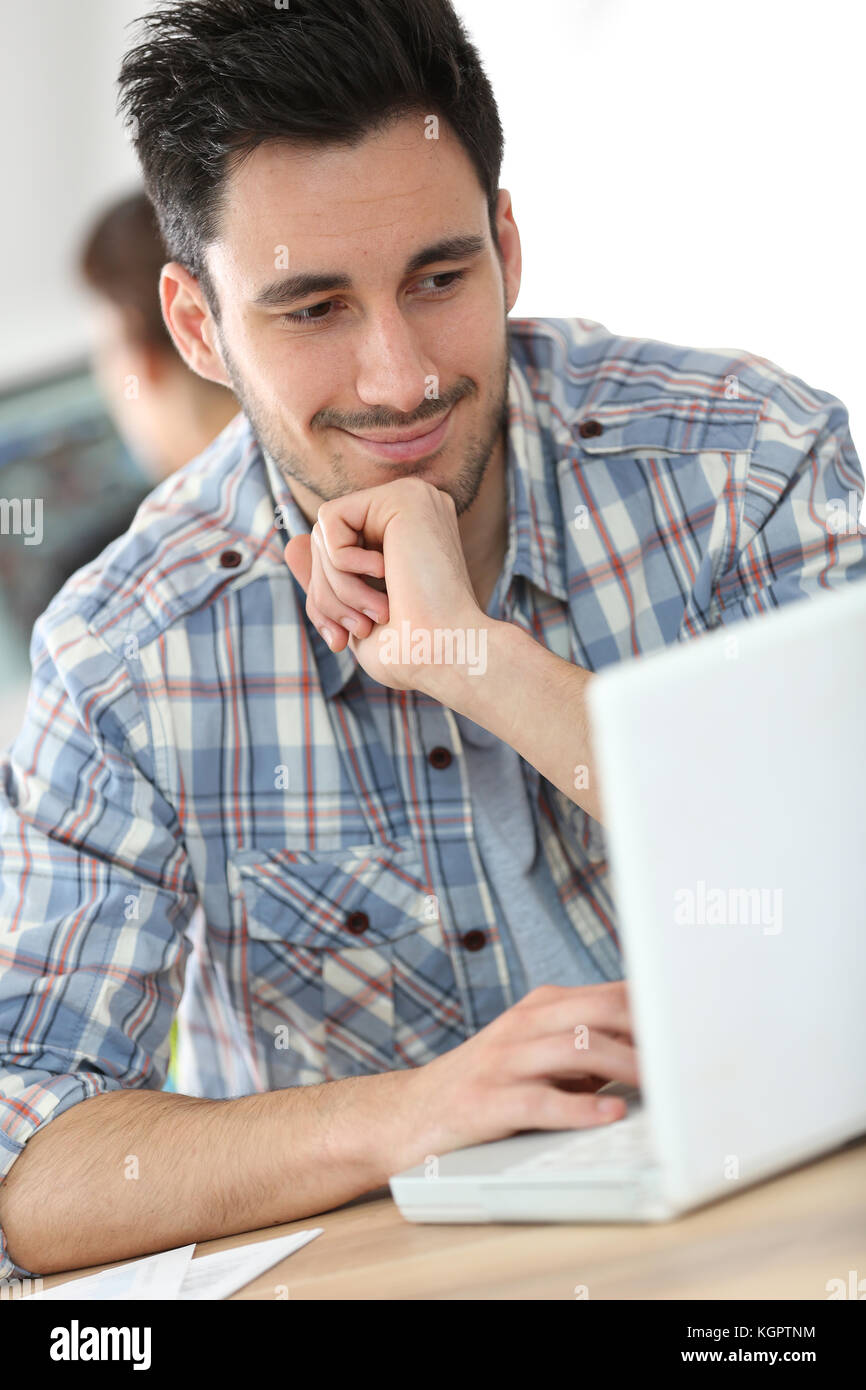 Young man working in office on computer Stock Photo - Alamy