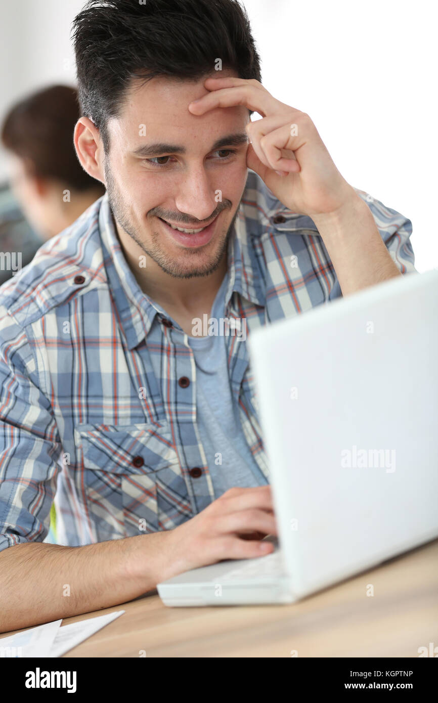 Young man working in office on computer Stock Photo - Alamy