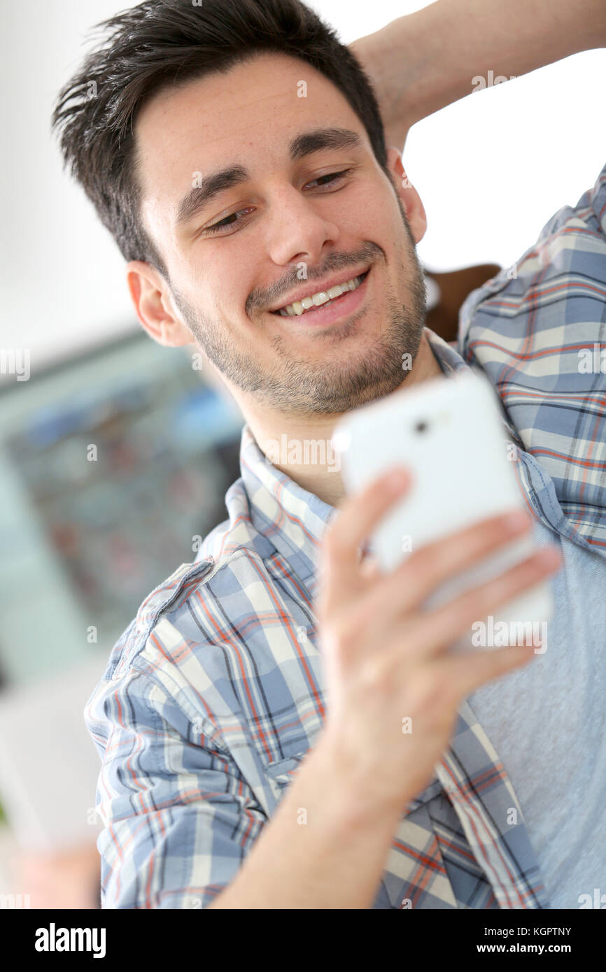 Office worker using smartphone at work Stock Photo - Alamy