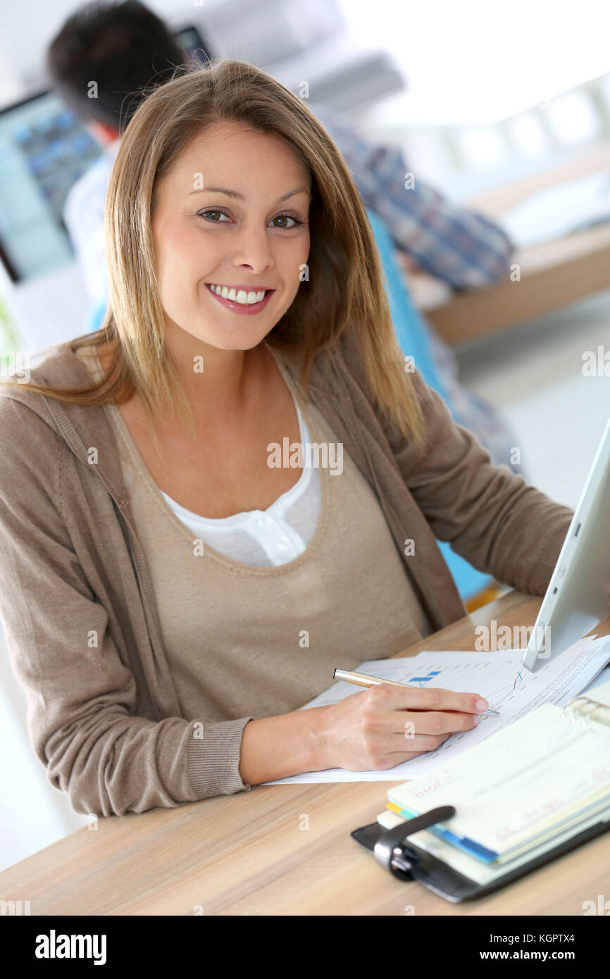 Portrait of smiling office worker using digital tablet Stock Photo - Alamy