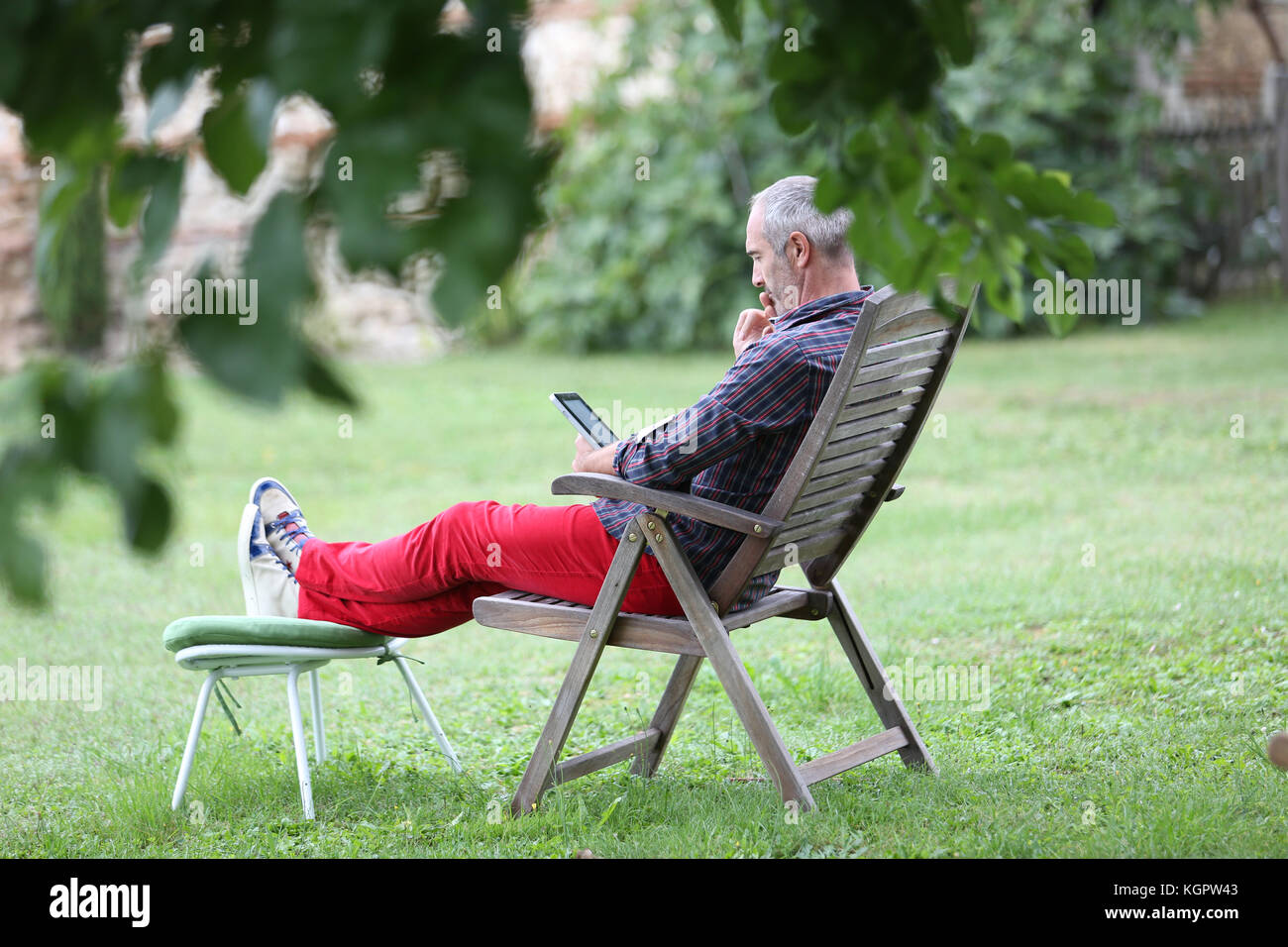 Mature man relaxing tablet hi-res stock photography and images - Alamy