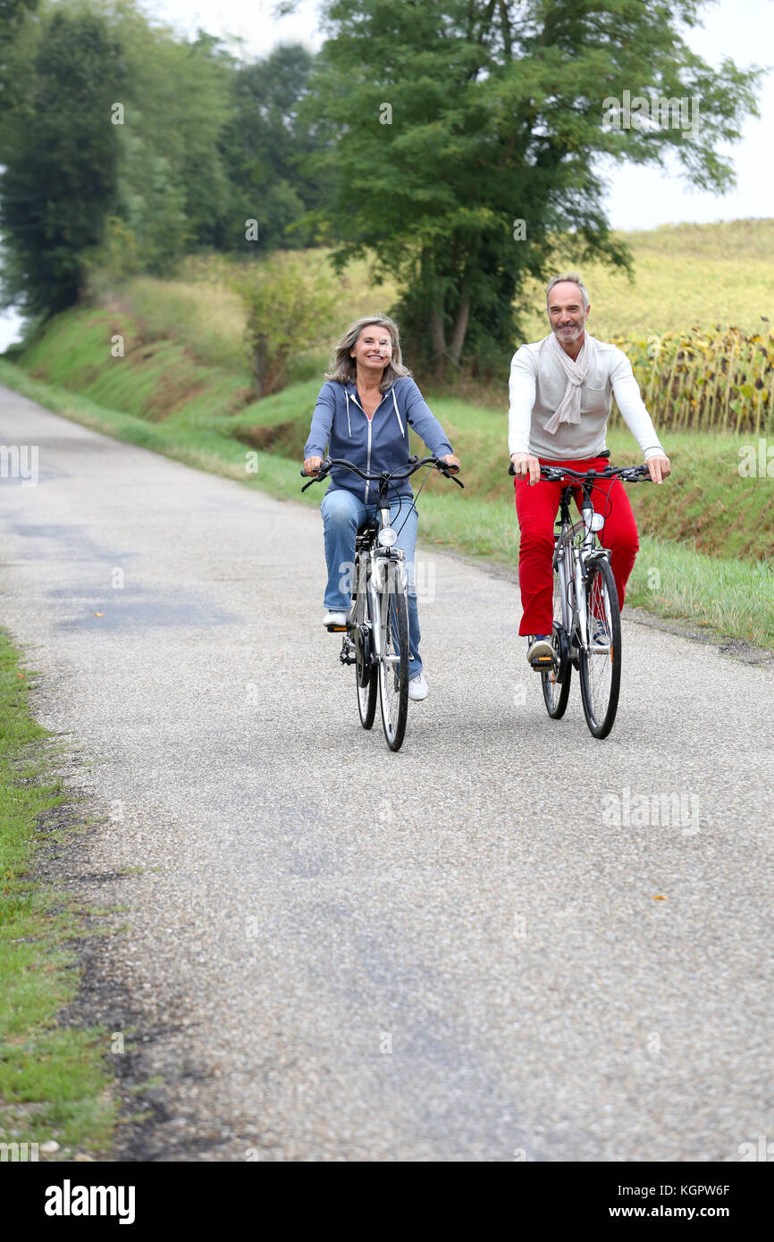 Mature Couple Riding Bike In High Resolution Stock Photography and ...