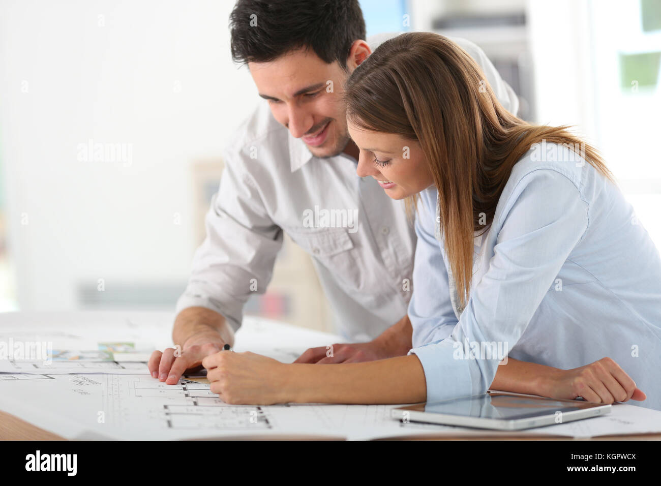 Team of architects working together on project Stock Photo - Alamy