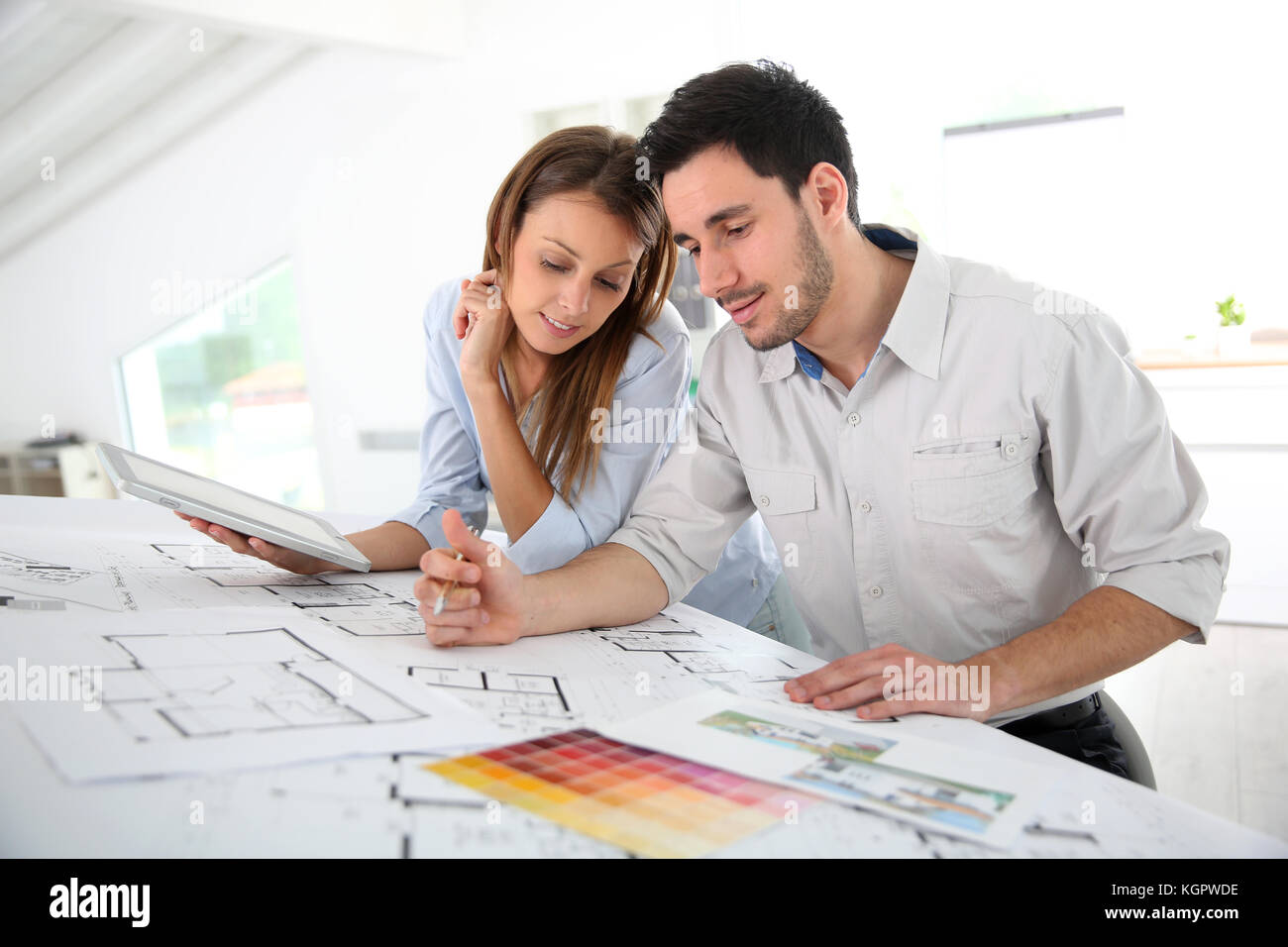 Team of architects working together on project Stock Photo - Alamy