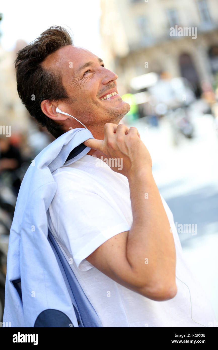 Trendy handsome man talking on phone with handsfree Stock Photo - Alamy