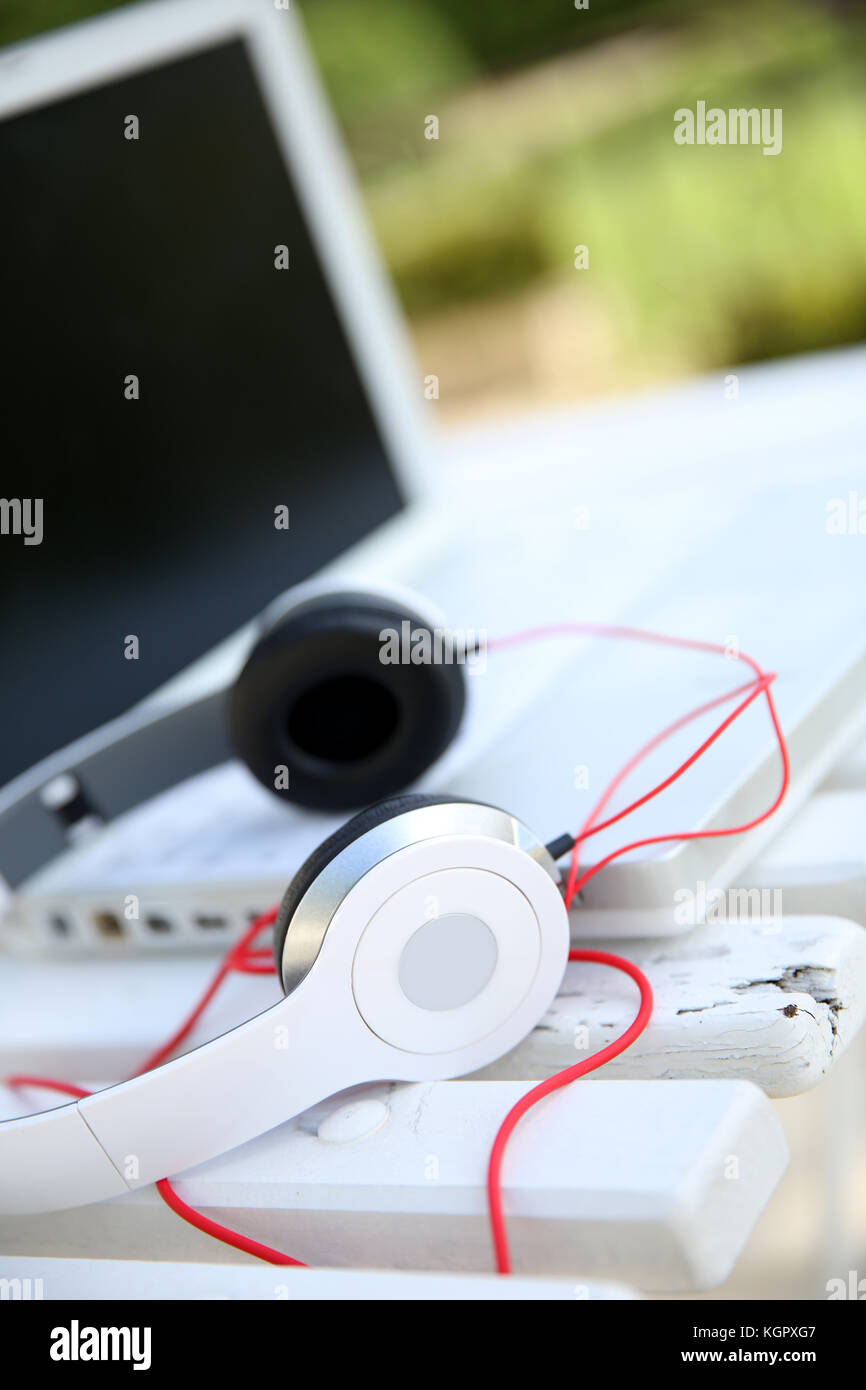 Closeup of headphones and laptop computer Stock Photo - Alamy