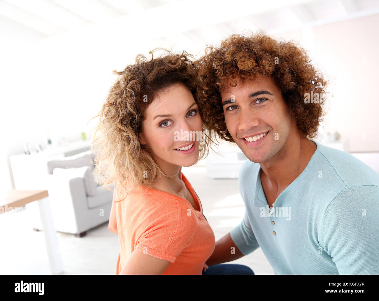 Cheerful couple standing in their new place Stock Photo - Alamy