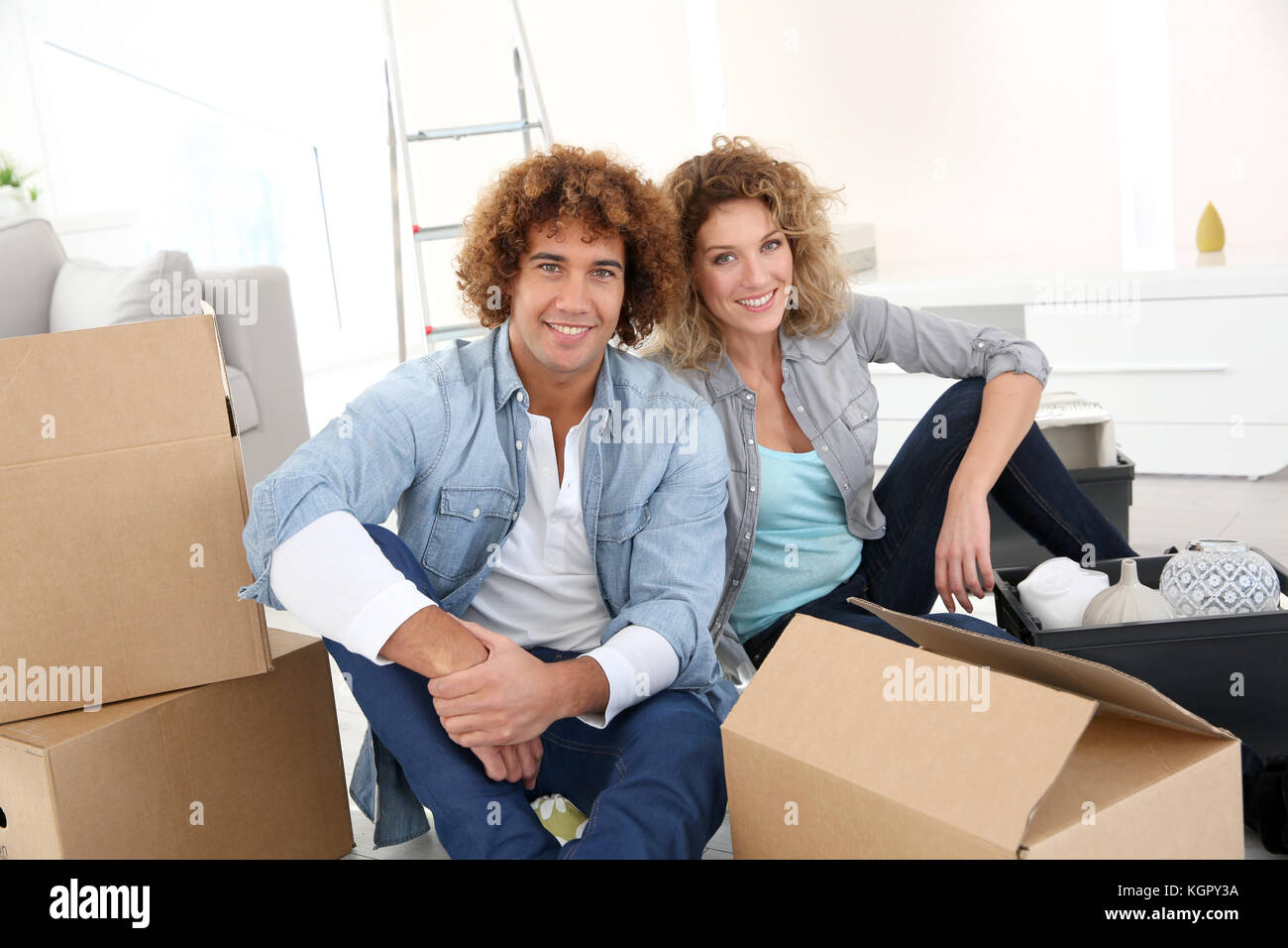 Couple getting in their new apartment to live together Stock Photo - Alamy