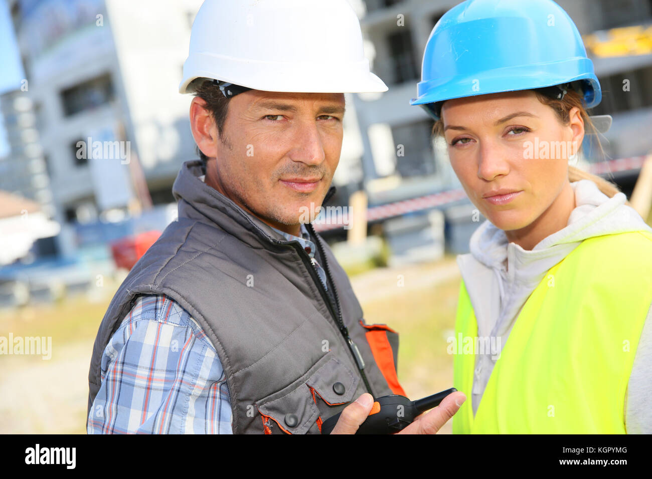 Construction partners standing on building site Stock Photo - Alamy