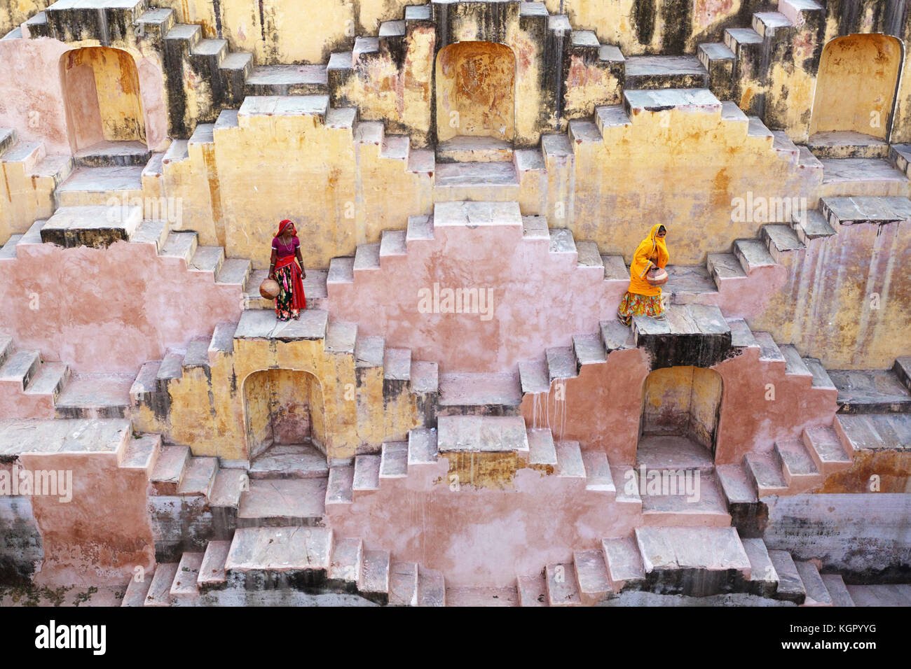 Two local women in traditional dress walking at the stepwell Panna ...