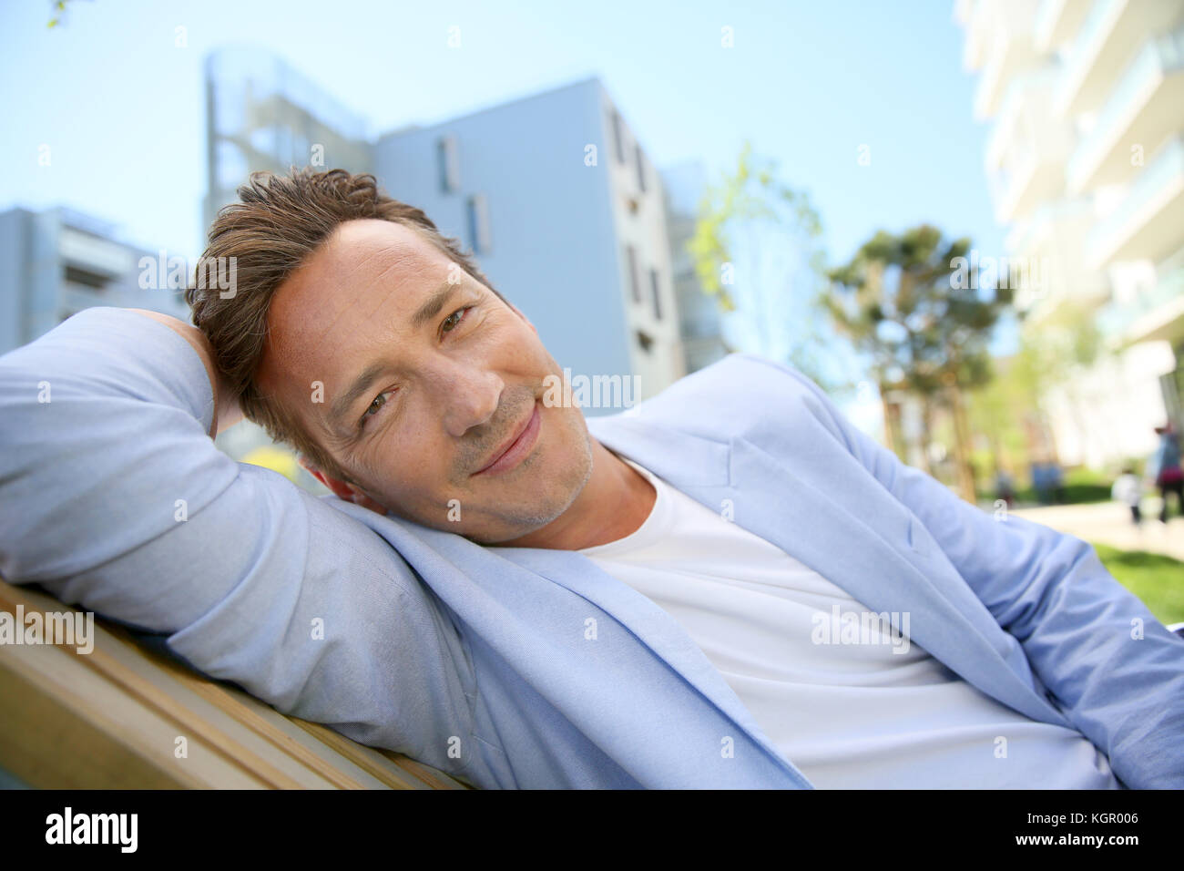 Handsome 40-year-old man relaxing in park Stock Photo - Alamy