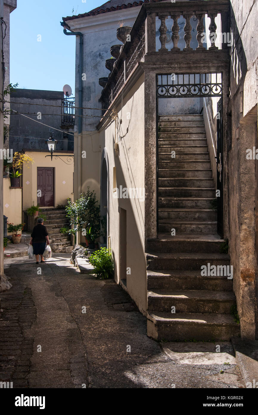 An old woman walks in the streets of the village of Aieta, Italy. Aieta ...