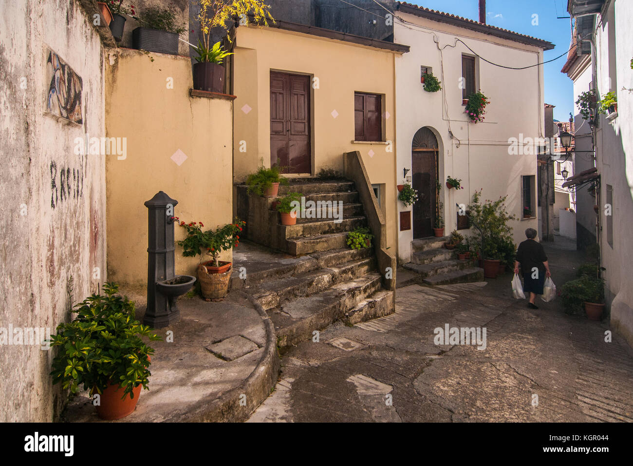 An old woman walks in the streets of the village of Aieta, Italy. Aieta ...