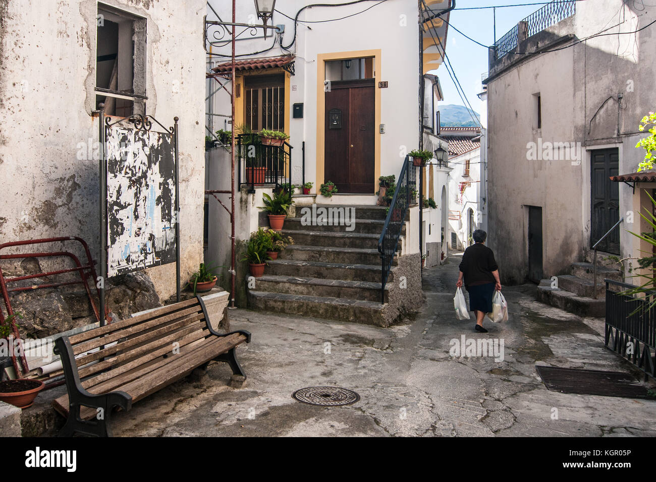An old woman walks in the streets of the village of Aieta, Italy. Aieta ...