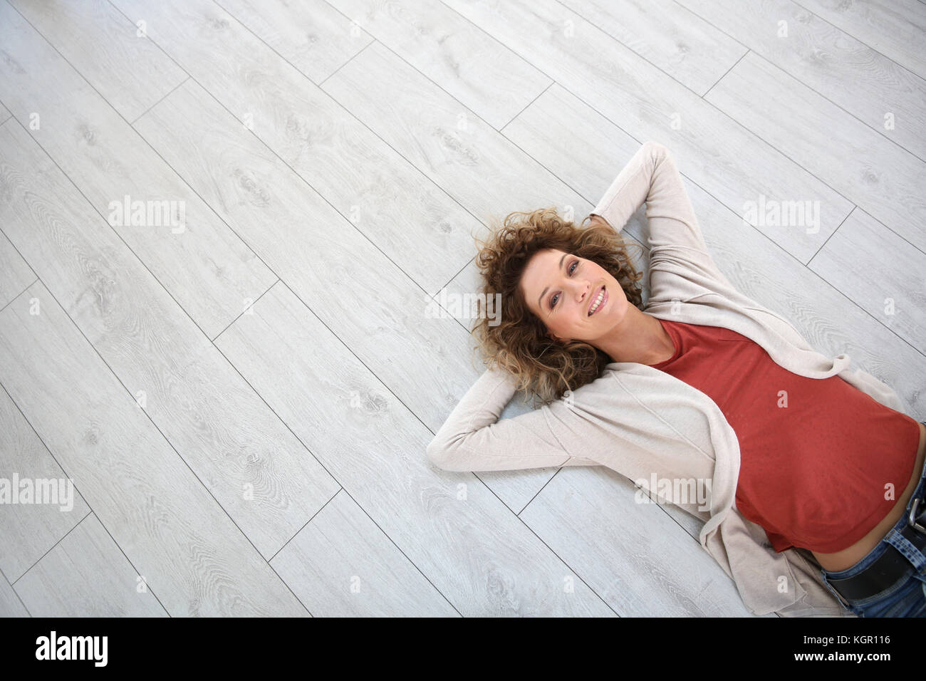 Woman laying on wooden modern flooring Stock Photo - Alamy
