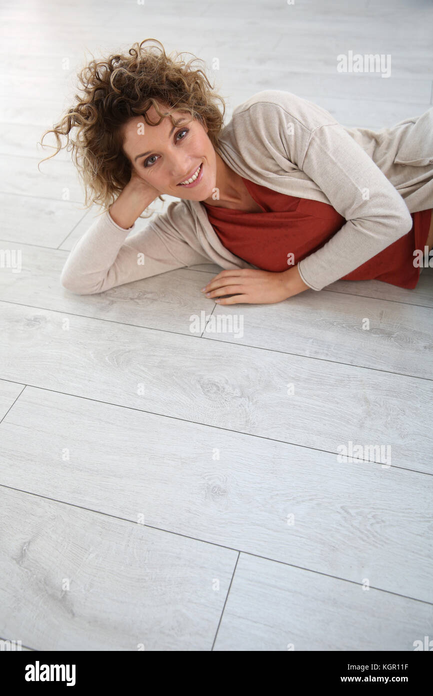 Woman laying on wooden modern flooring Stock Photo - Alamy