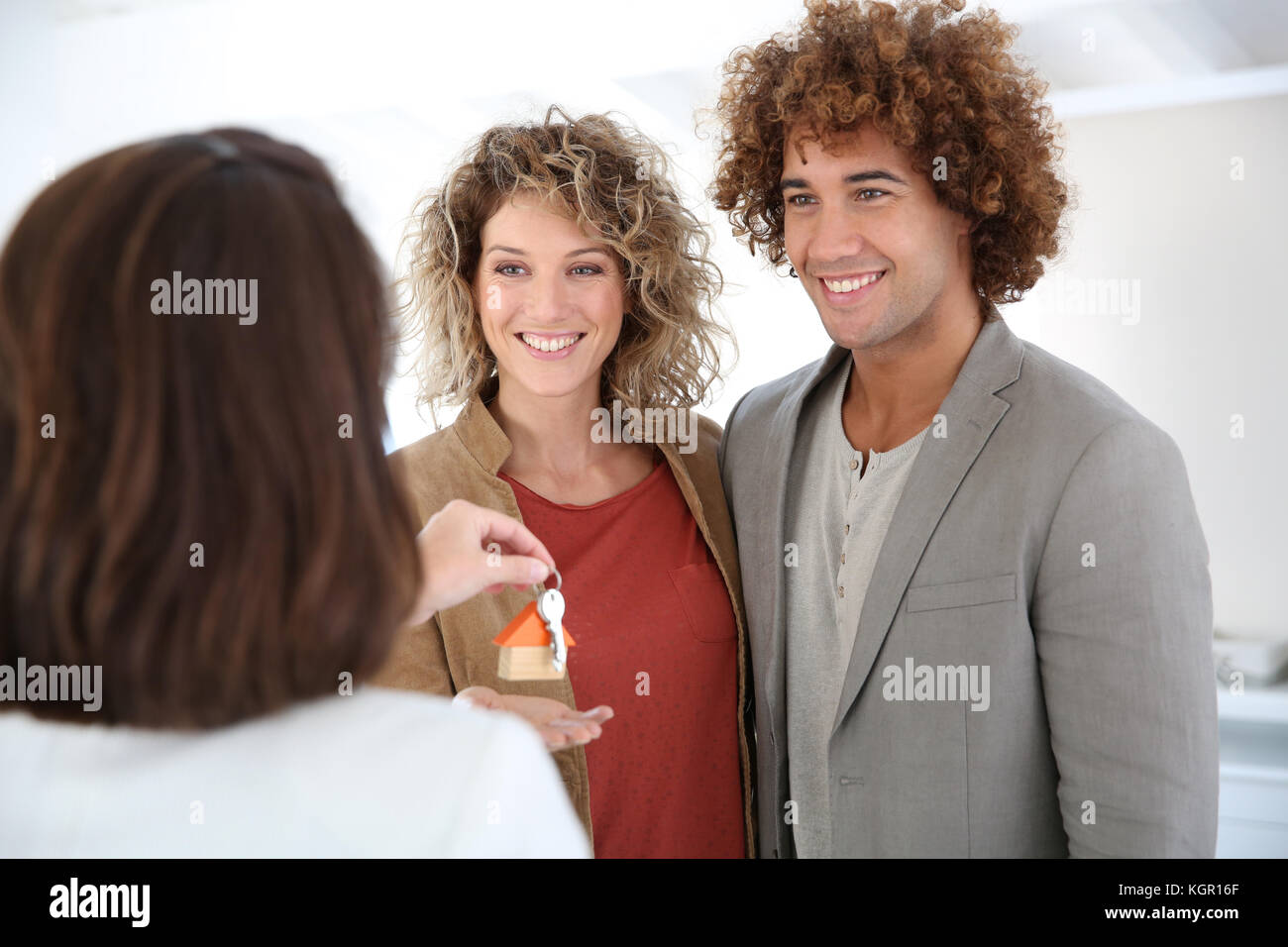 Cheerful couple getting keys of their new home Stock Photo - Alamy