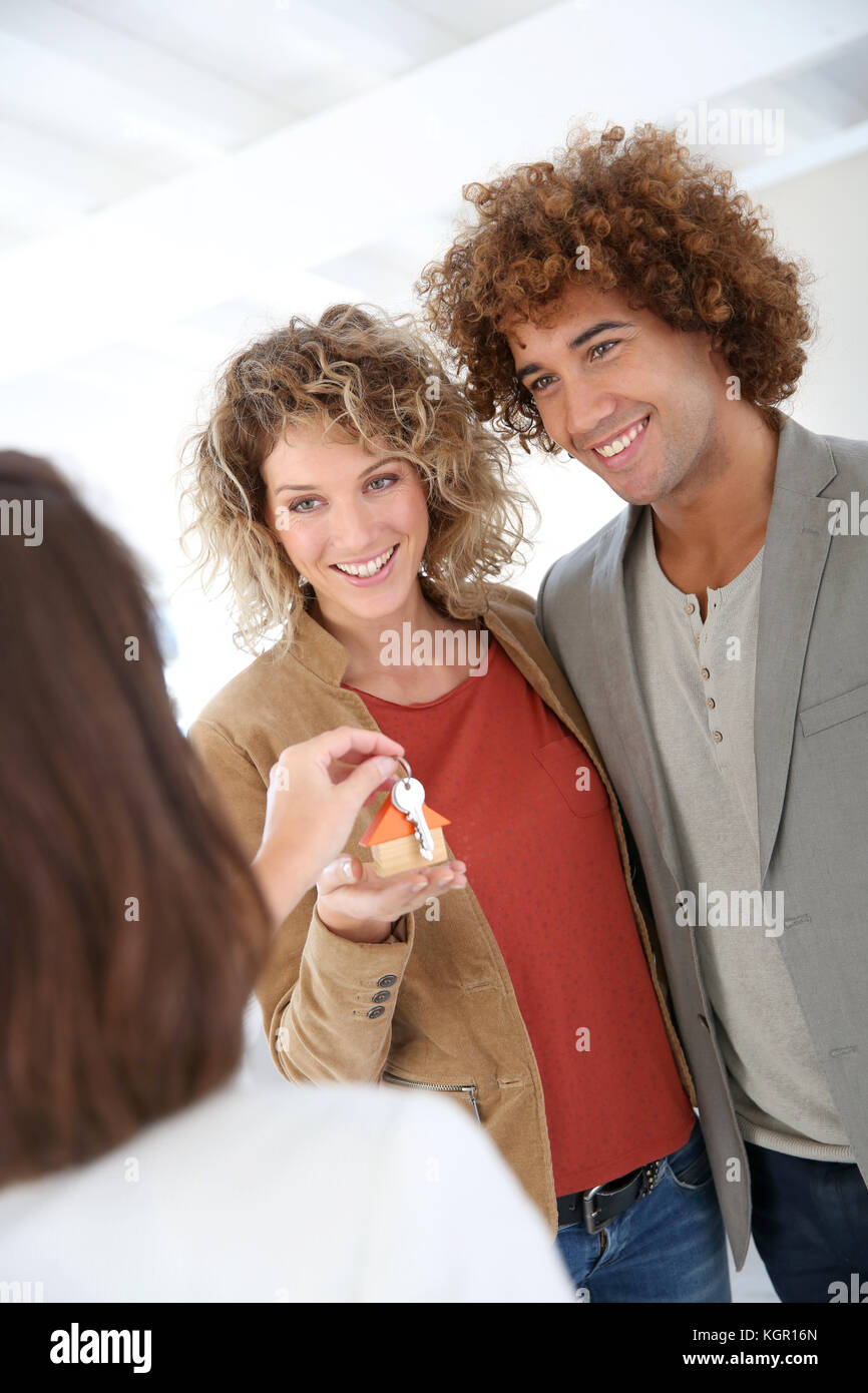 Cheerful couple getting keys of their new home Stock Photo - Alamy