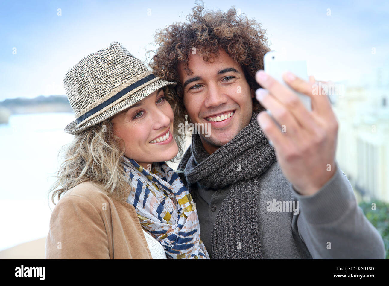 Cheerful couple taking picture with smartphone Stock Photo - Alamy