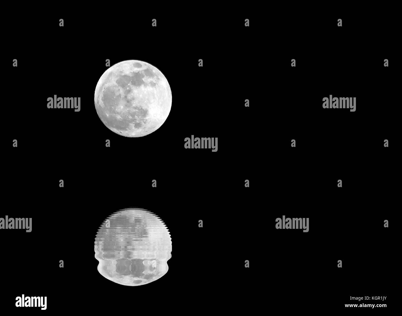 beautiful full moon and lunar reflection on the surface of the water ...