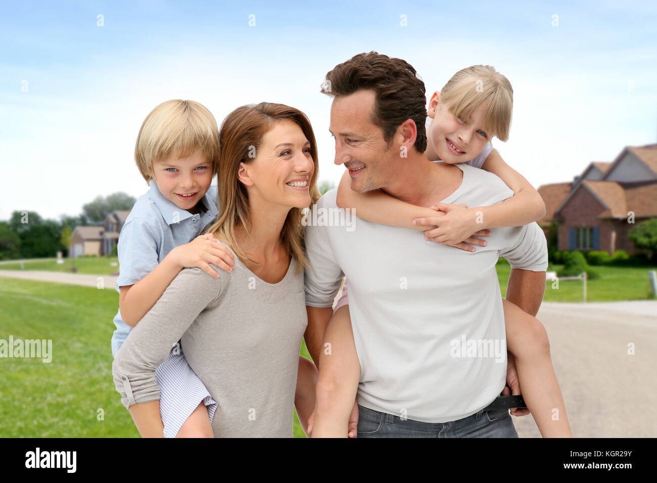 Parents and children standing in neighborhood Stock Photo - Alamy