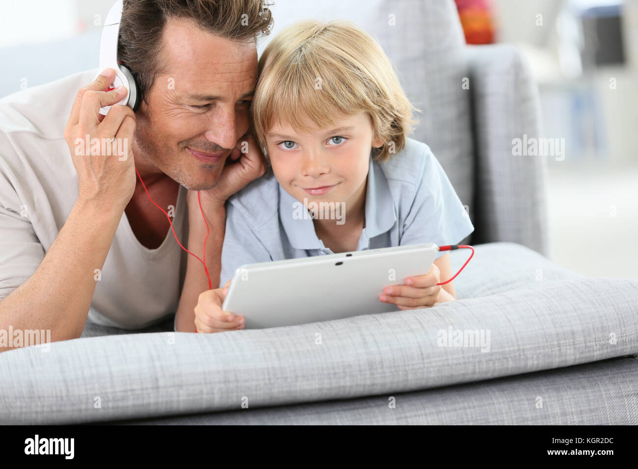Father and son listening to music on tablet Stock Photo - Alamy